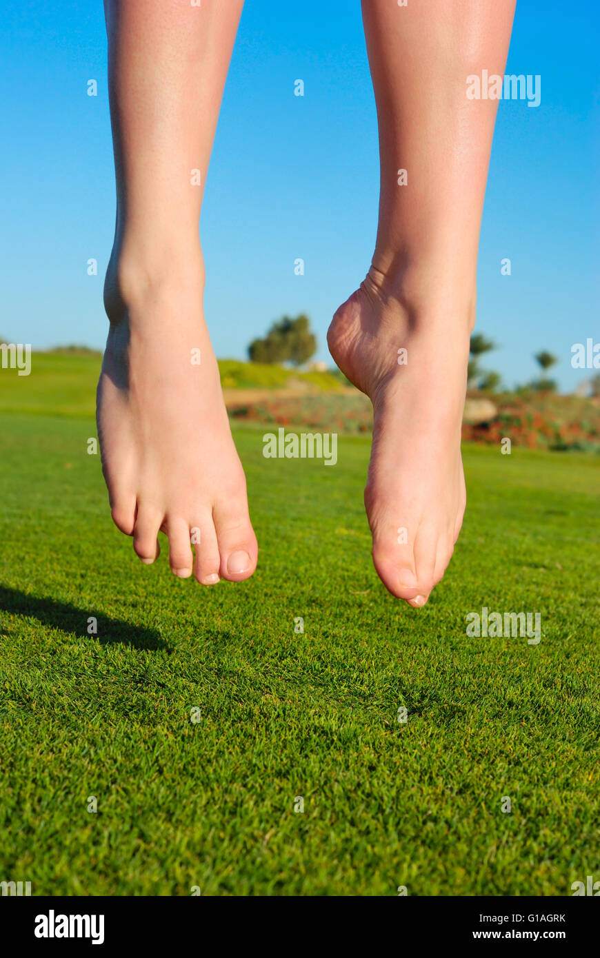 closeup of feet of jumping on green field woman Stock Photo - Alamy