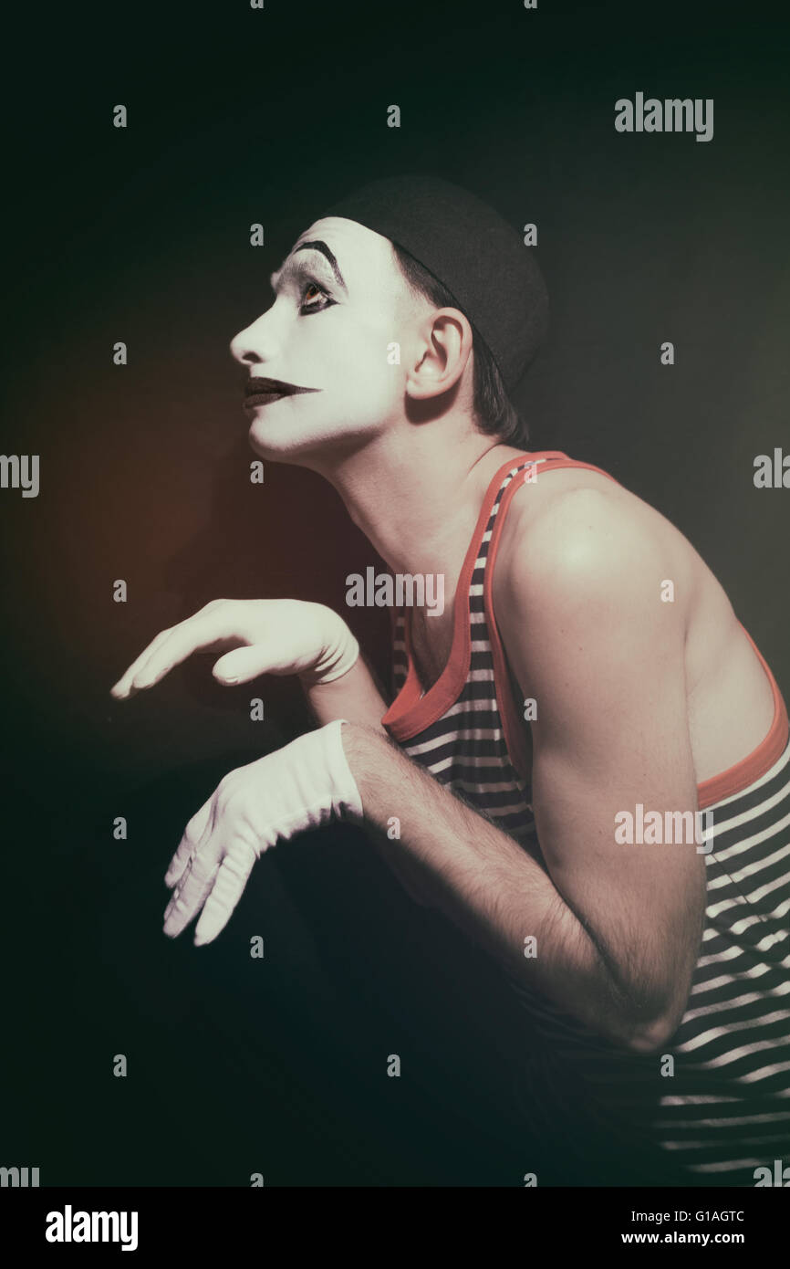 Portrait of stalking actor mime on a black background Stock Photo - Alamy