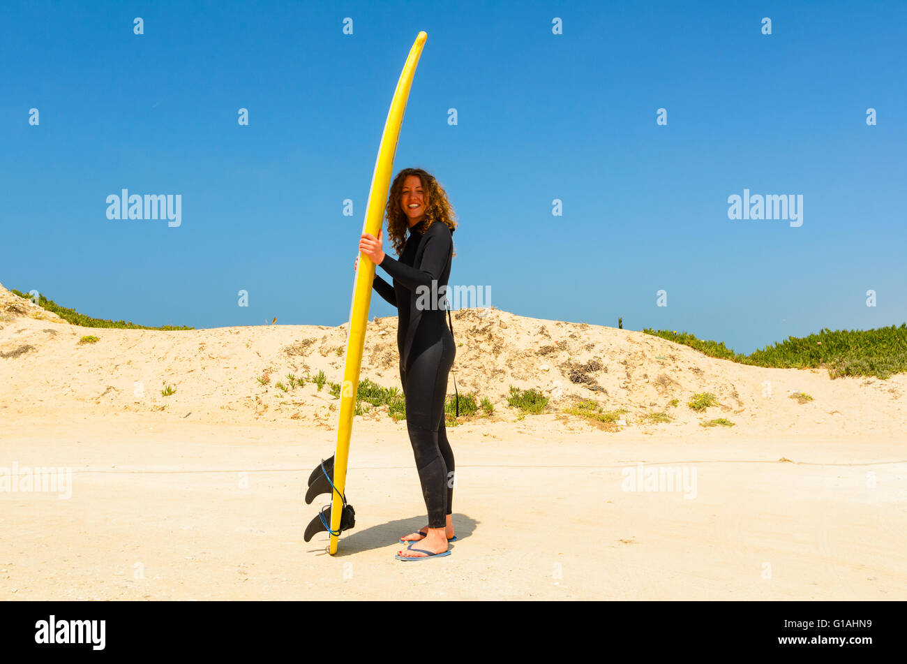 Woman holding surfing board hi-res stock photography and images - Alamy