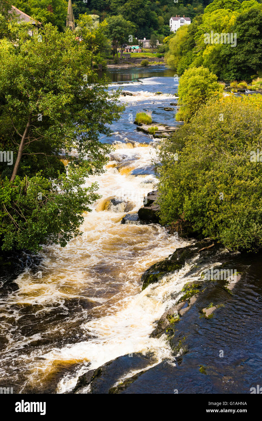 The sun shining over the waterfalls in the centre of Llangollen in ...