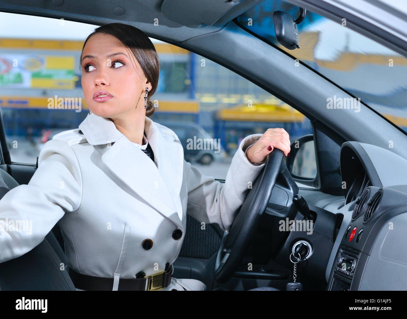 woman in a car is looking backwards trying to move back Stock Photo - Alamy
