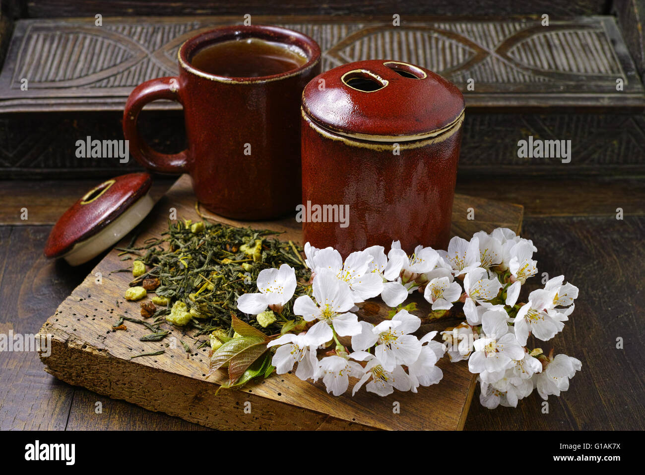 Japan's tea cups with green tea on wooden plank and sakura flowers on ...