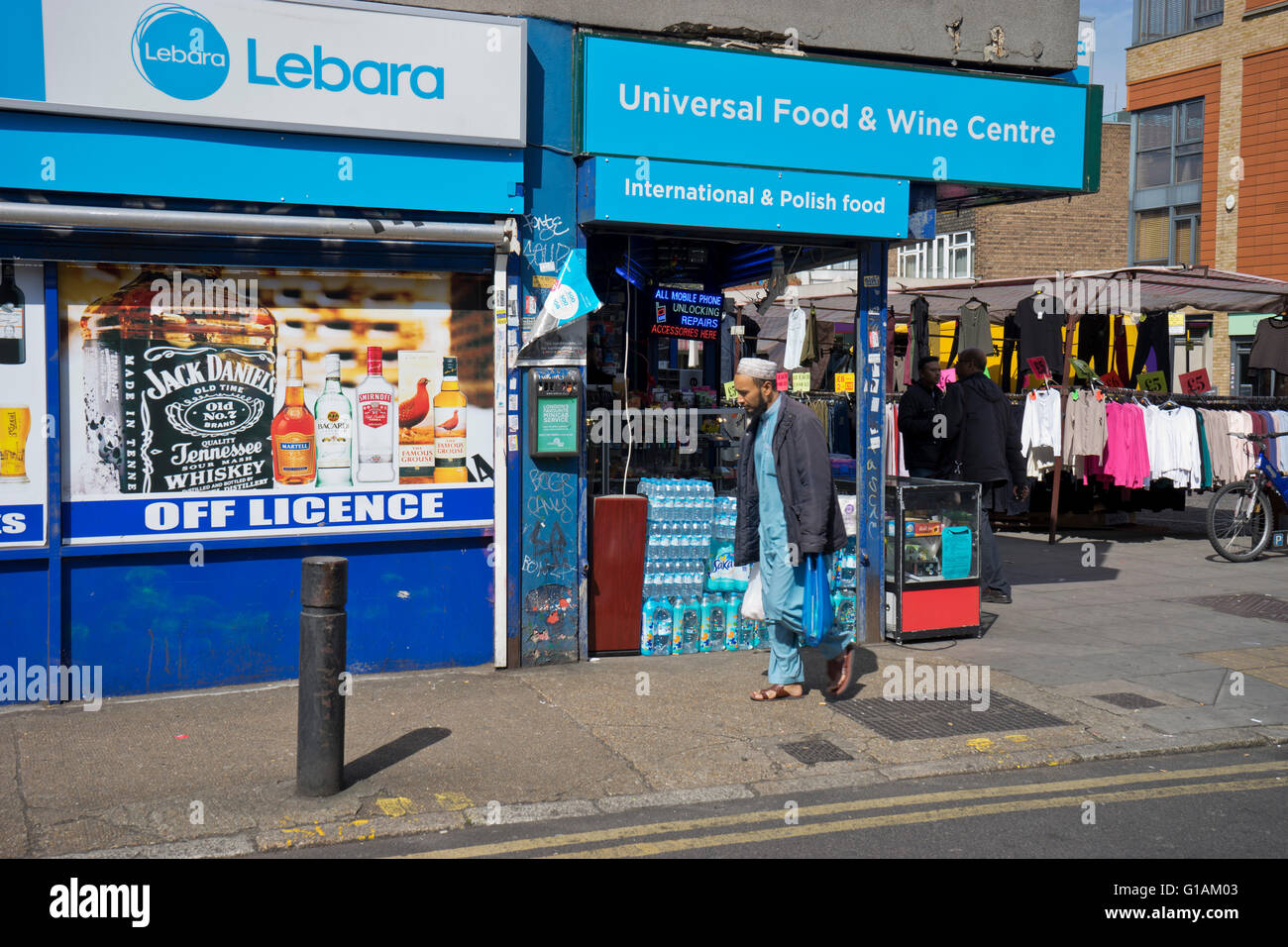 Muslim man walks past an off-license alcohol shop in Whitechapel ...