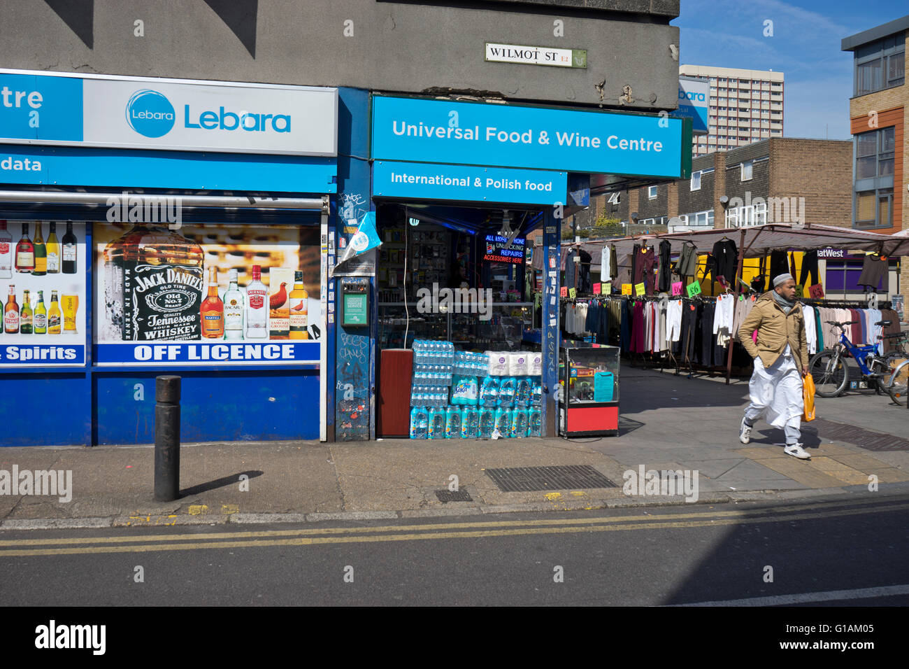 Muslim man walks past an off-license alcohol shop in Whitechapel ...