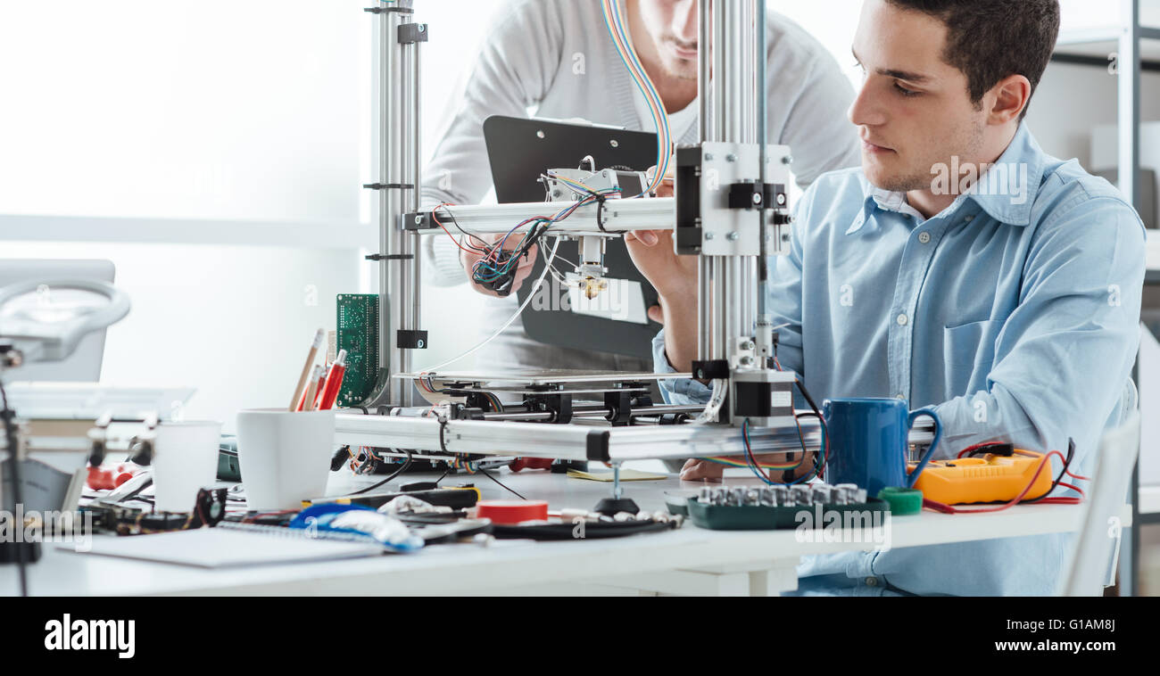Engineering students using an innovative 3D printer in the laboratory ...