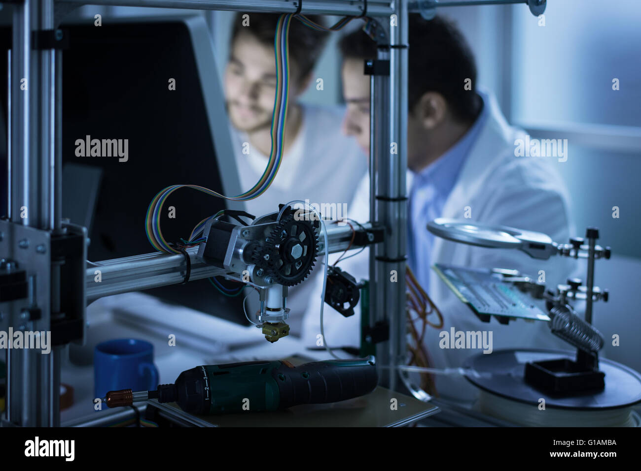 Young engineers working in the laboratory and using a computer, 3D ...