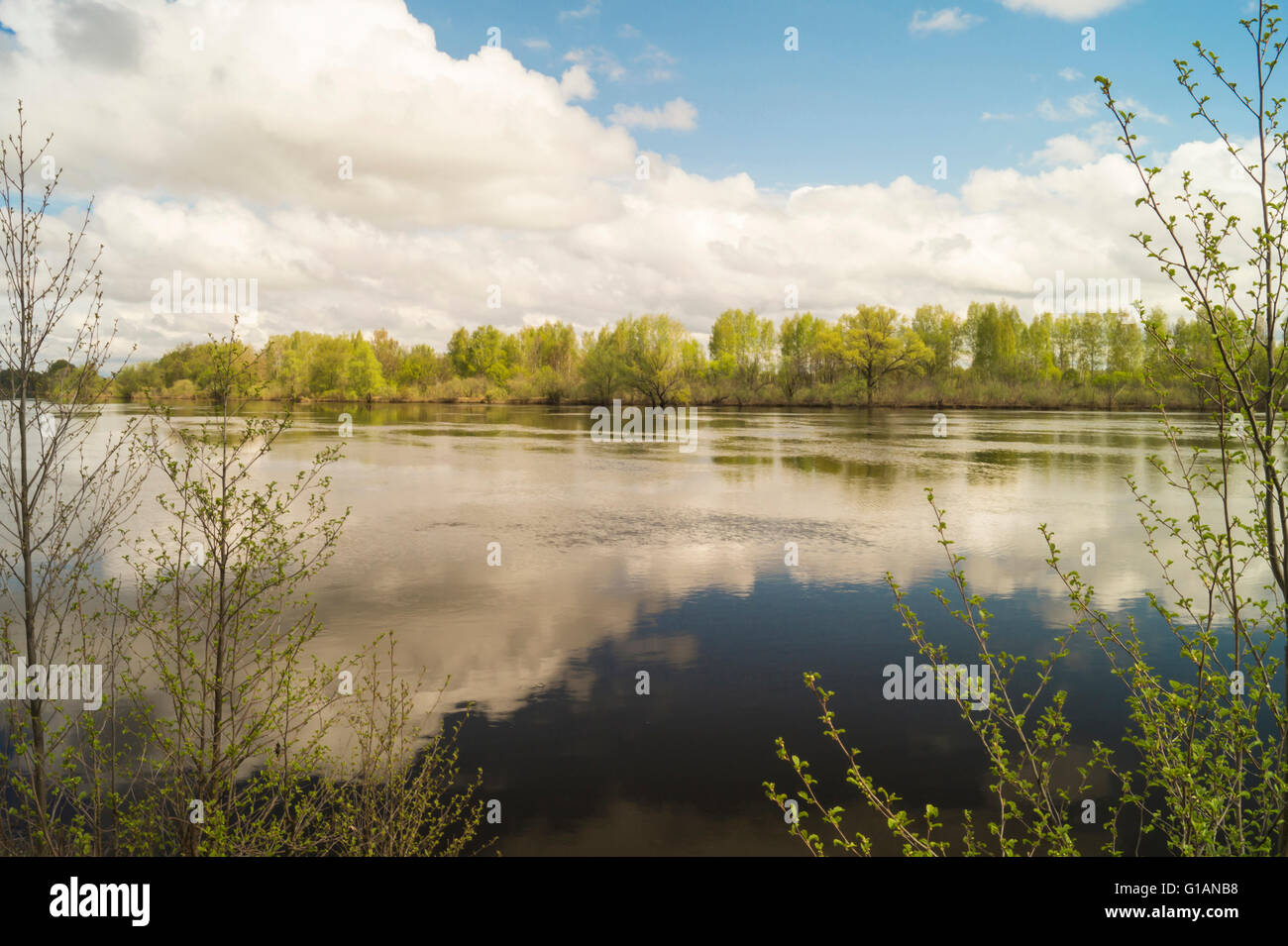 Spring landscape with river on background beautiful sky and reflections ...