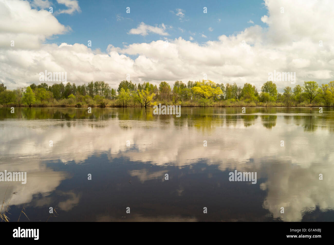 Spring landscape with river on background beautiful sky and reflections ...
