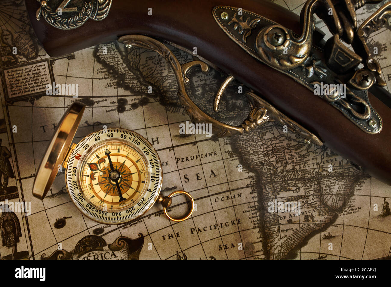 Pirate background. Ancient map and antique handgun and brass compass ...