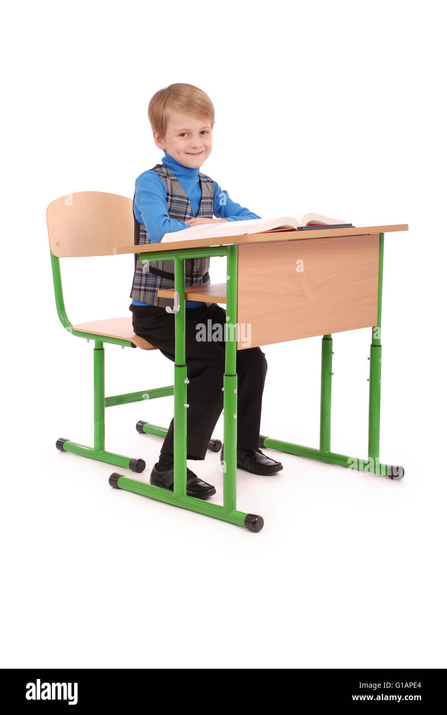 Boy sitting at a school desk isolated on white Stock Photo - Alamy