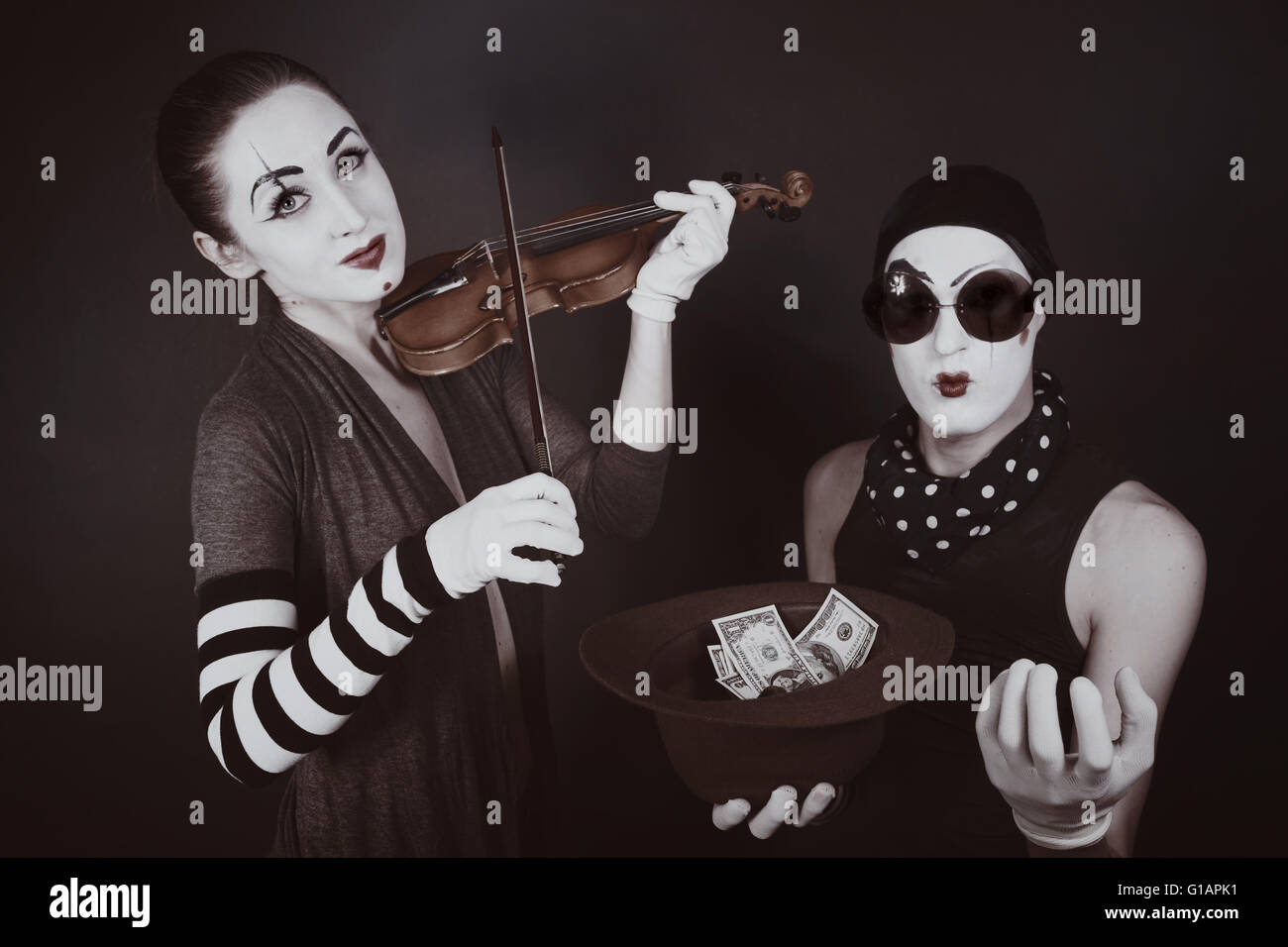 Portrait of Two mimes playing a violin for the money Stock Photo - Alamy