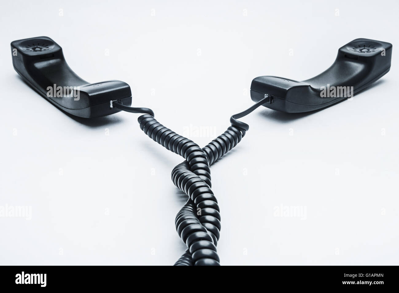 Black telephone receiver with cable on white background Stock Photo - Alamy