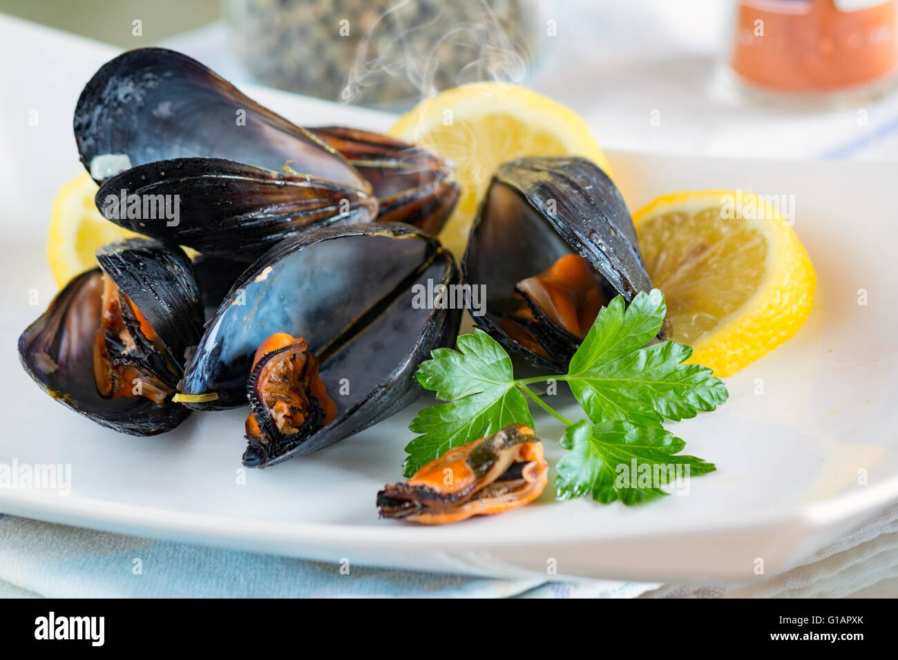 plate of peppered mussels with lemon Stock Photo - Alamy