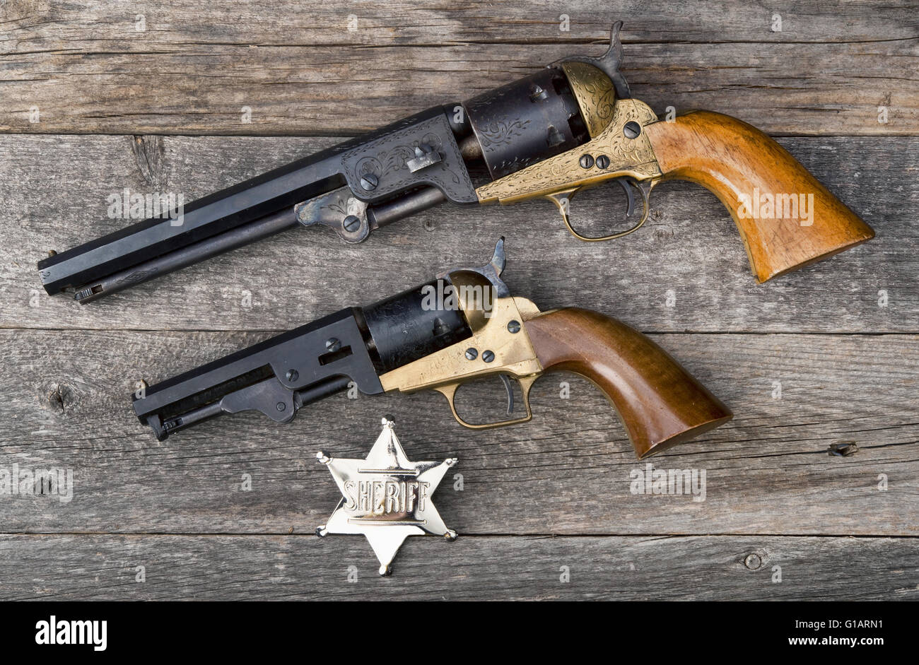 The guns that won the west and silver sheriff badge Stock Photo - Alamy