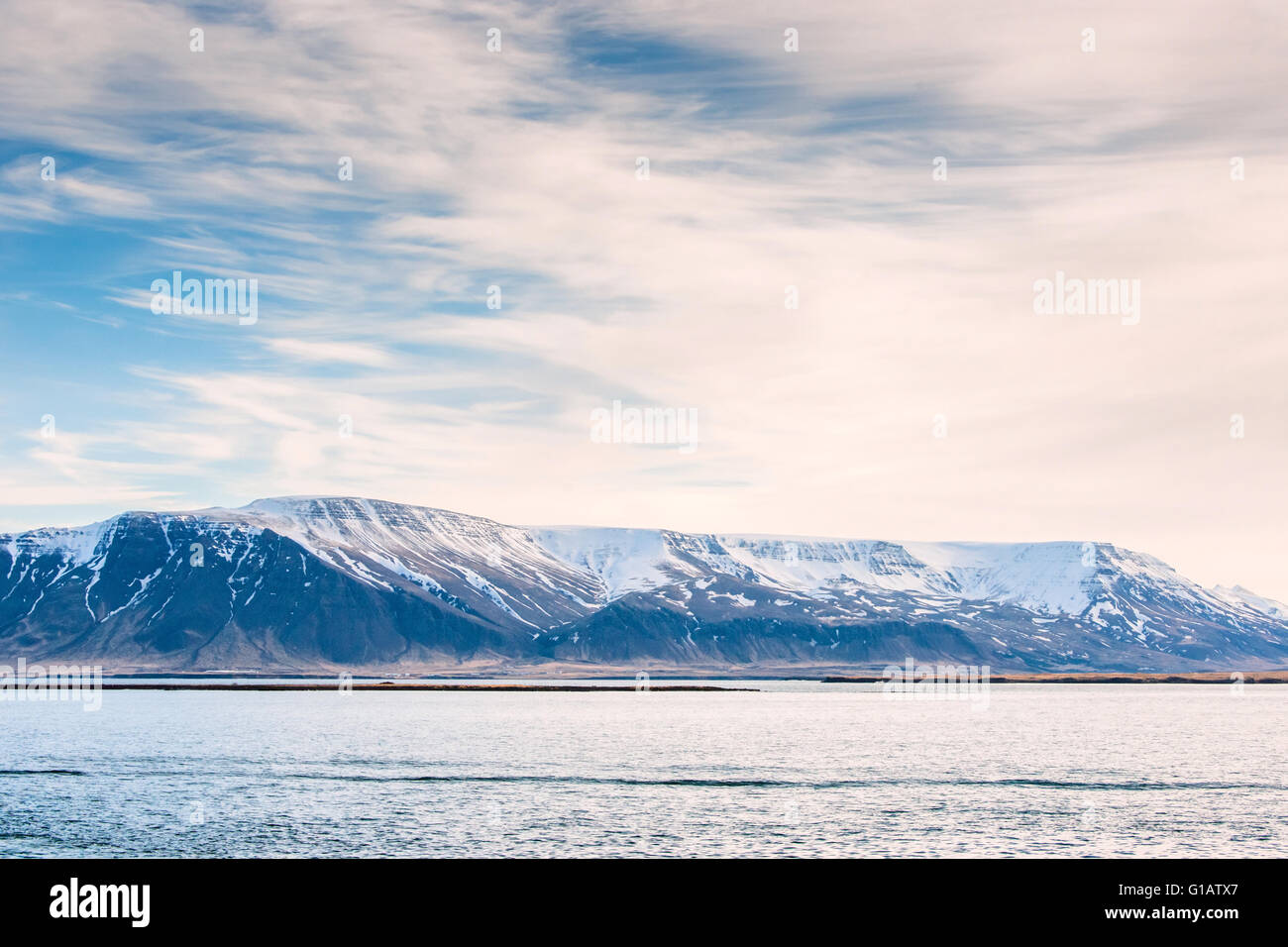 Mountain with snow in the ocean in Iceland Stock Photo - Alamy
