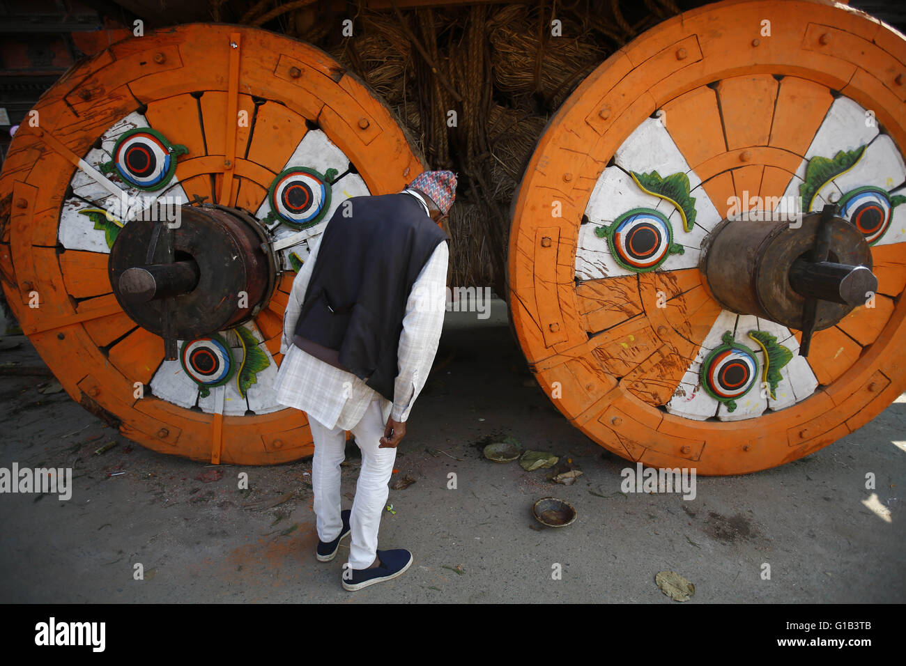 Lalitpur, Nepal. 12th May, 2016. A Nepalese devotee worships the wheels ...