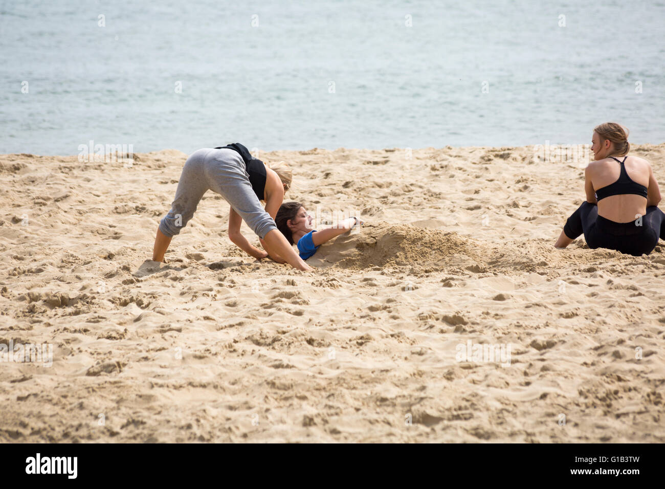 Woman buried in sand beach hi-res stock photography and images - Alamy