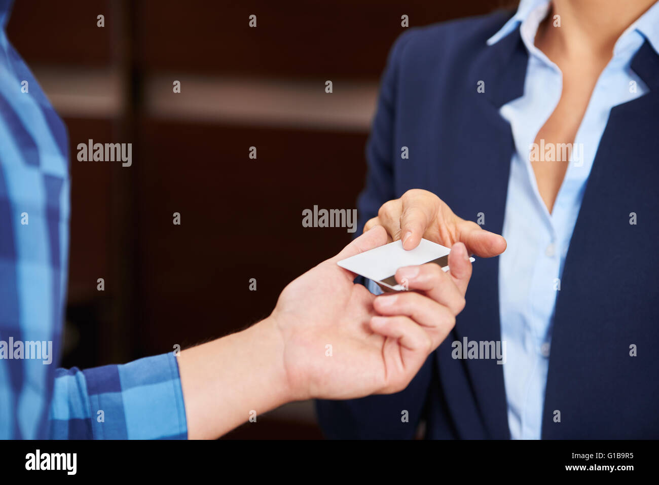 Guest at hotel reception taking key card from receptionist Stock Photo ...