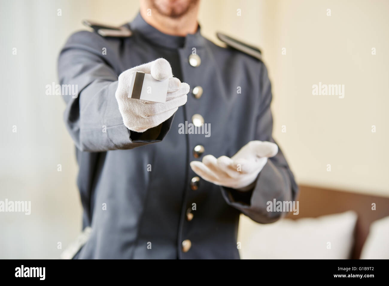 Concierge offering key card to hotel guest during check-in Stock Photo ...