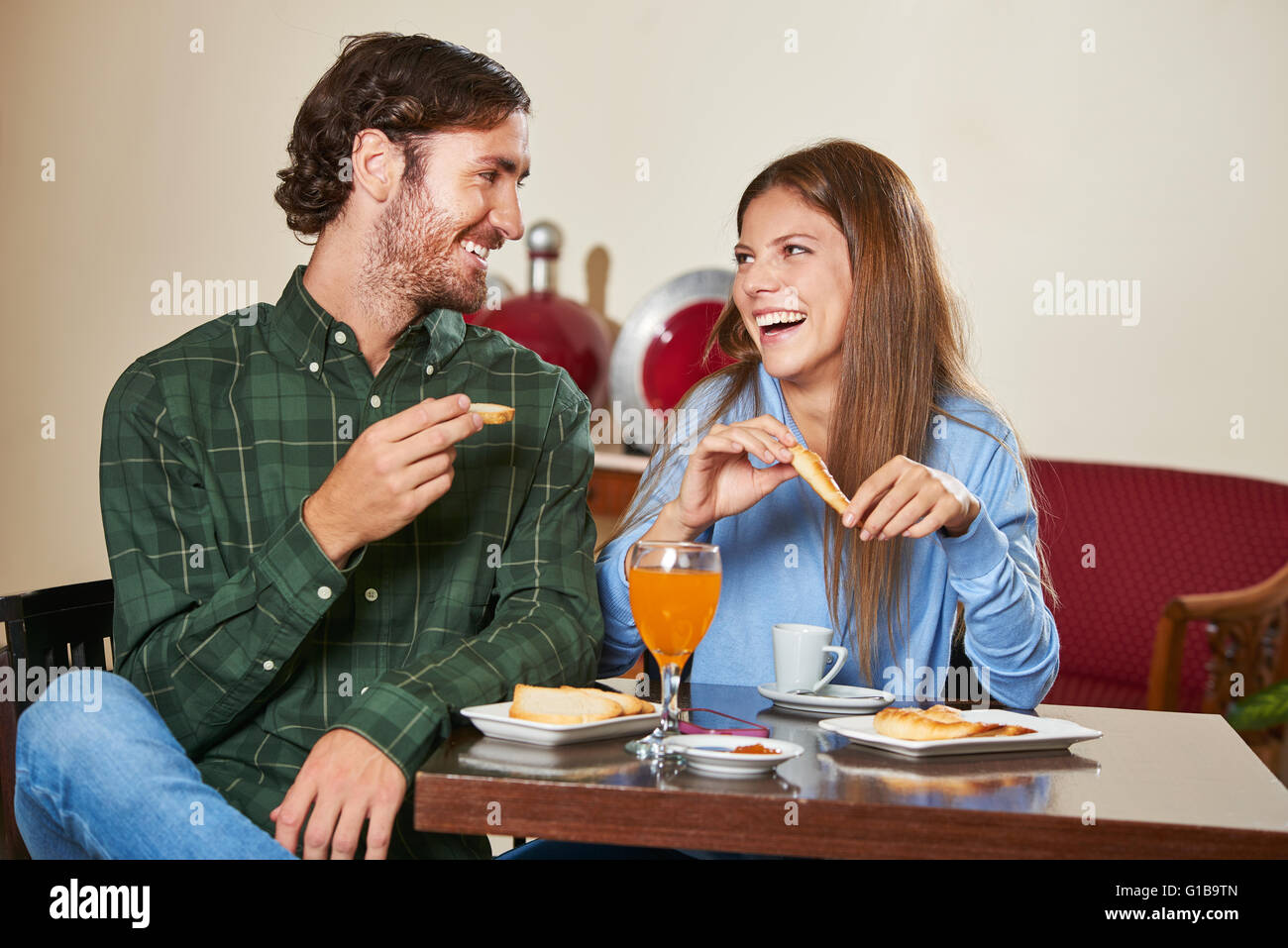 Happy couple eating breakfast in a hotel restaurant Stock Photo - Alamy