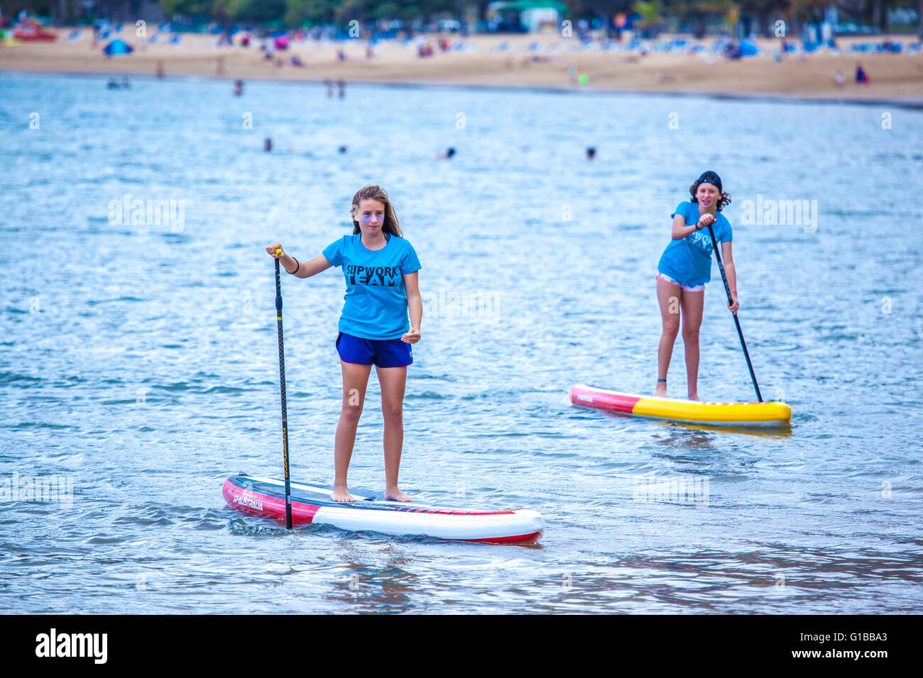 two girls doing Stand up paddle on the seaside Stock Photo - Alamy