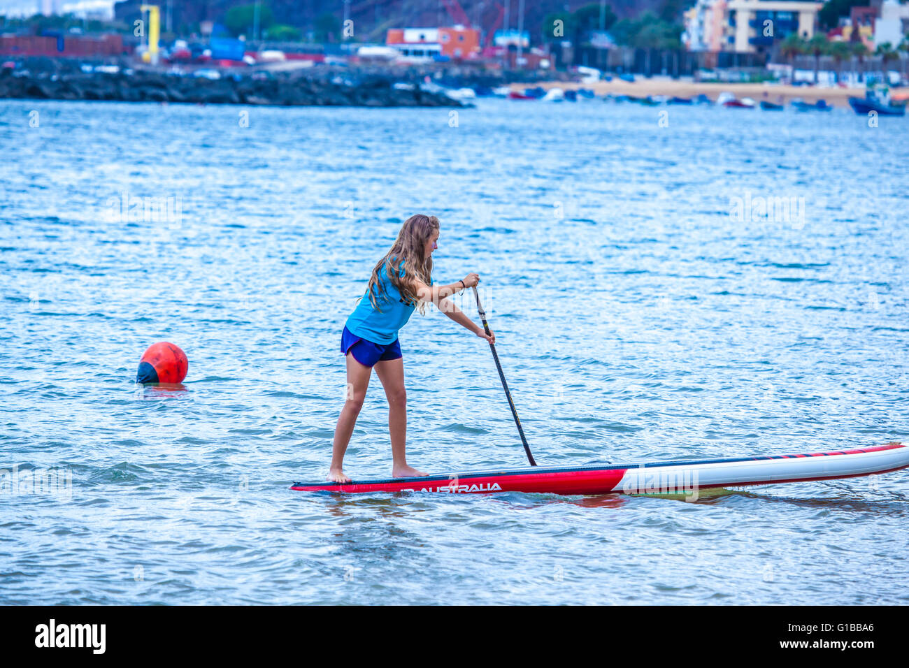 girl doing Stand up paddle on the seaside Stock Photo - Alamy