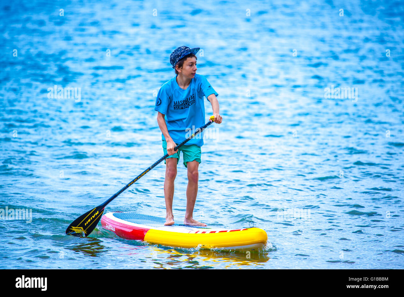 boy doing Stand up paddle on the seaside Stock Photo - Alamy