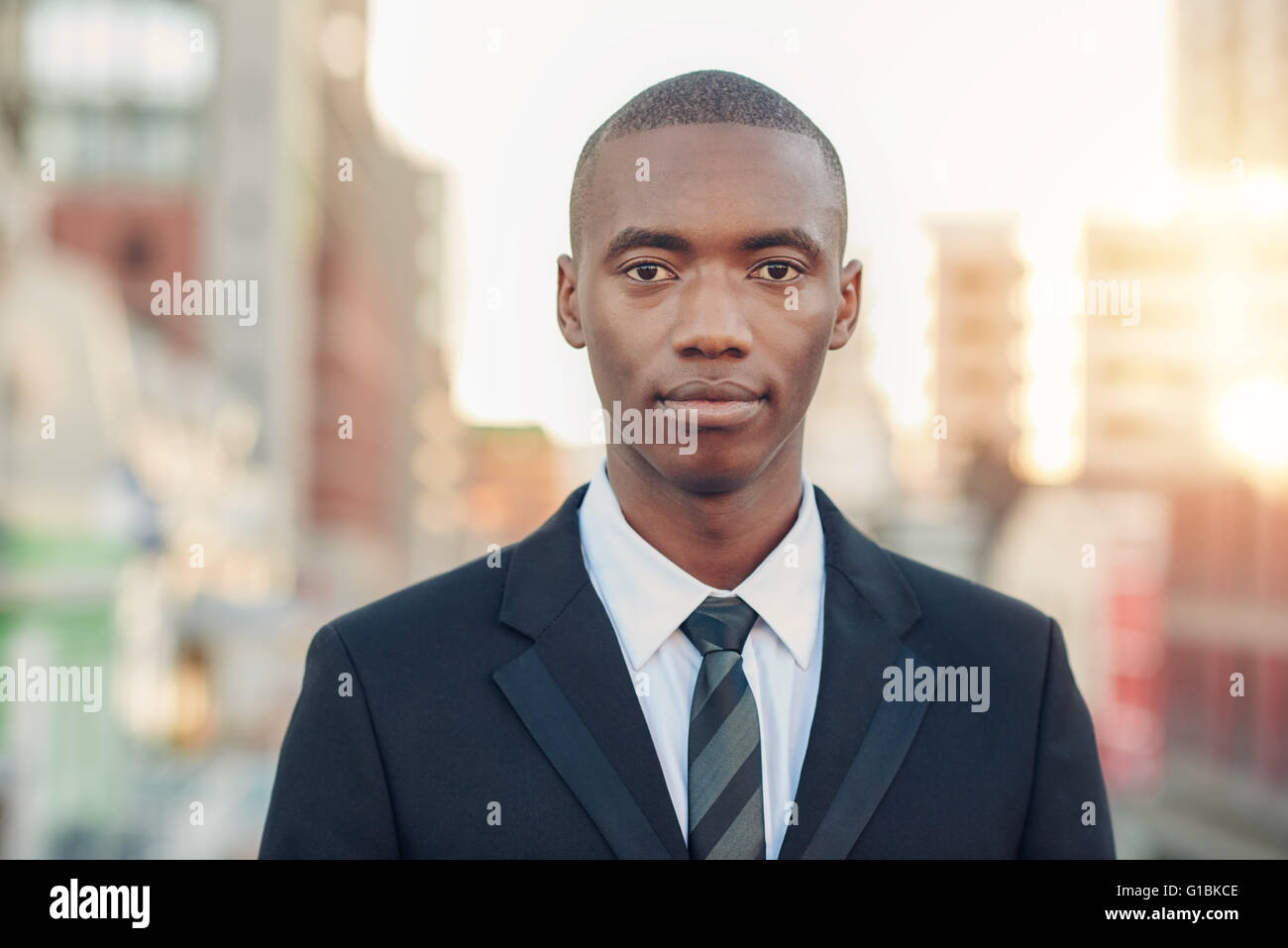 Portrait of a serious young African businessman in a corporate suit and ...