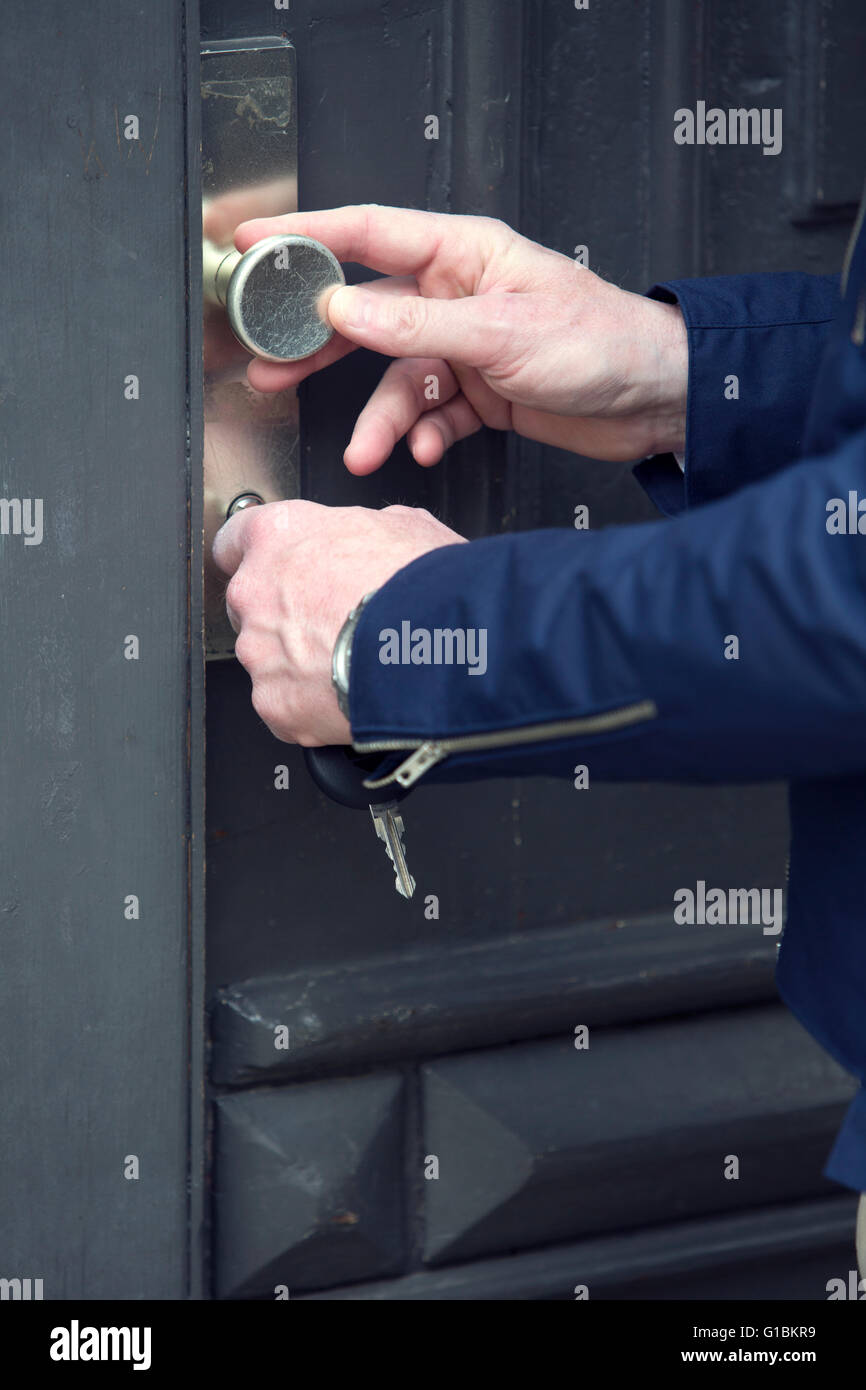 closeup of a man opening a door with his key Stock Photo - Alamy