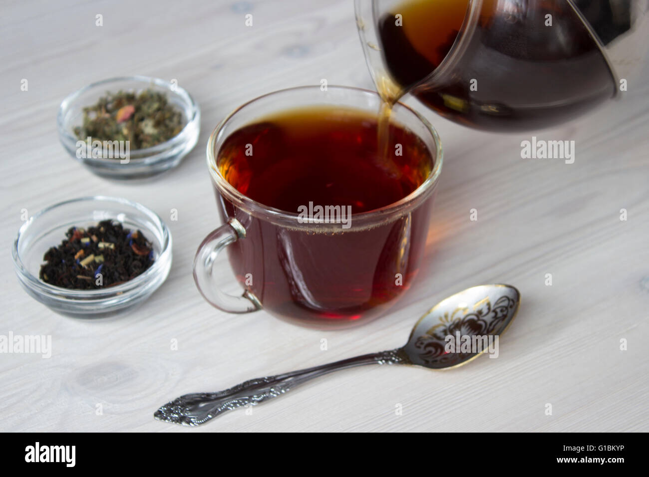 Tea being poured into tea cup Stock Photo - Alamy
