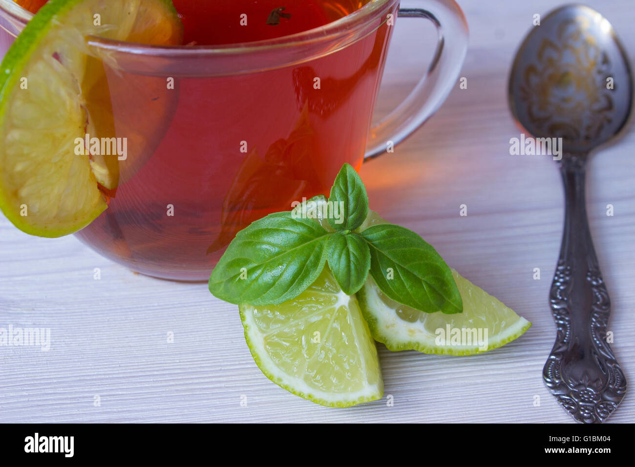Hot tea with lime in a cup Stock Photo - Alamy
