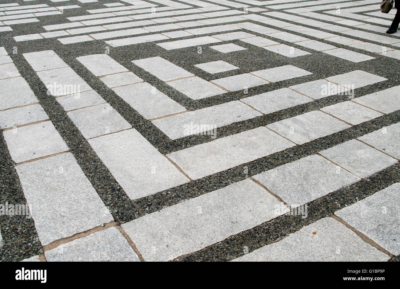 Man walking on abstract pattern pavement Stock Photo - Alamy