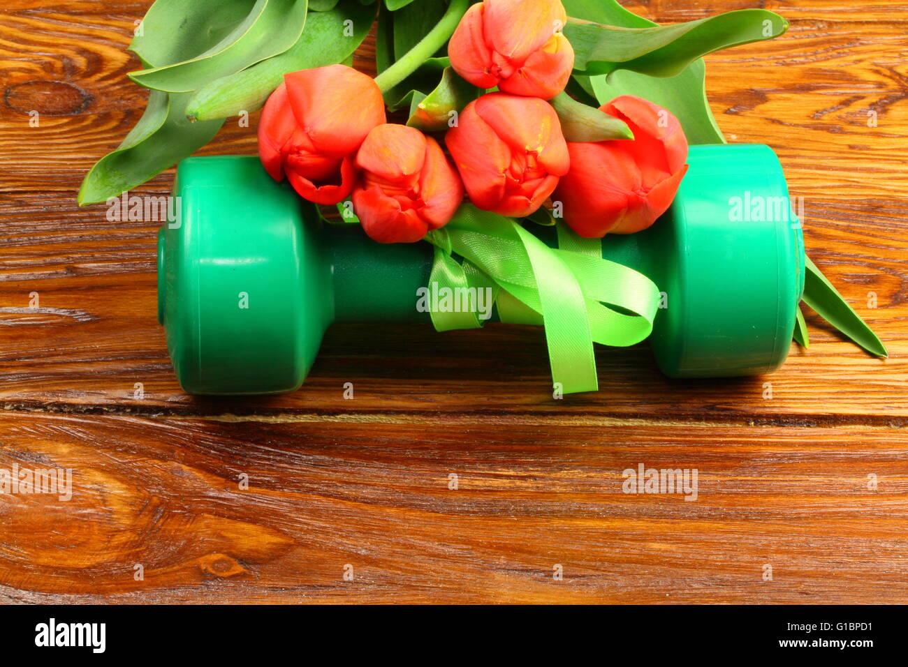 gift of flowers and dumbbells for fitness Stock Photo - Alamy
