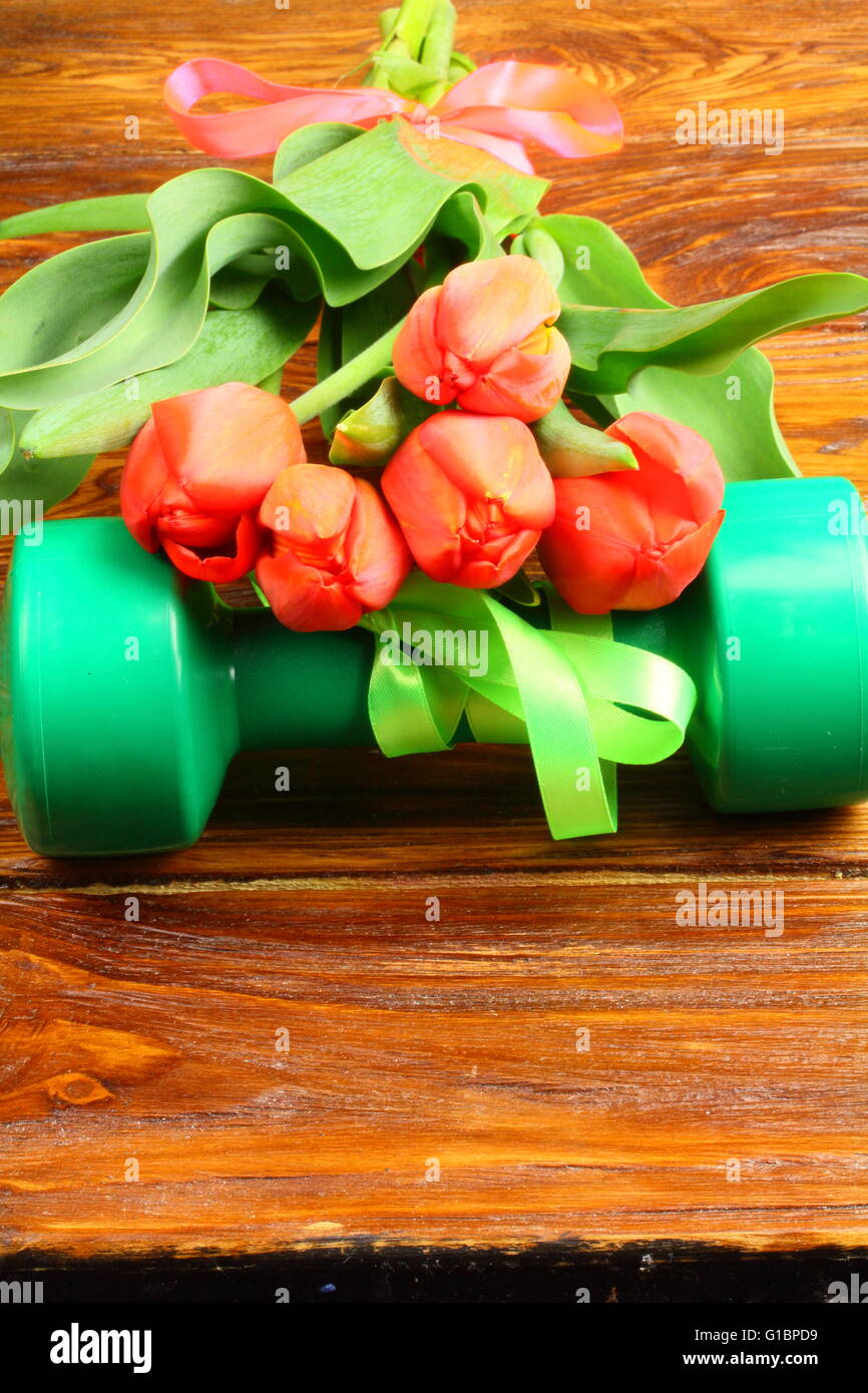 gift of flowers and dumbbells for fitness Stock Photo - Alamy