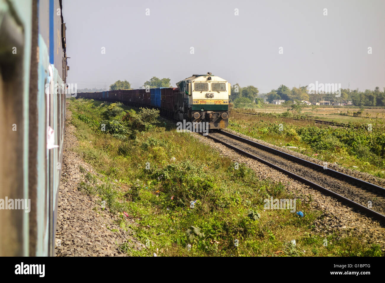 A Freight Train crossing Passenger Train on Northeast Frontier Railway ...