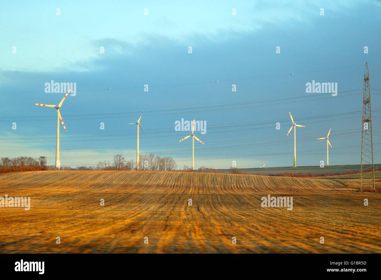Renewable alternative energy wind turbines in field Stock Photo - Alamy