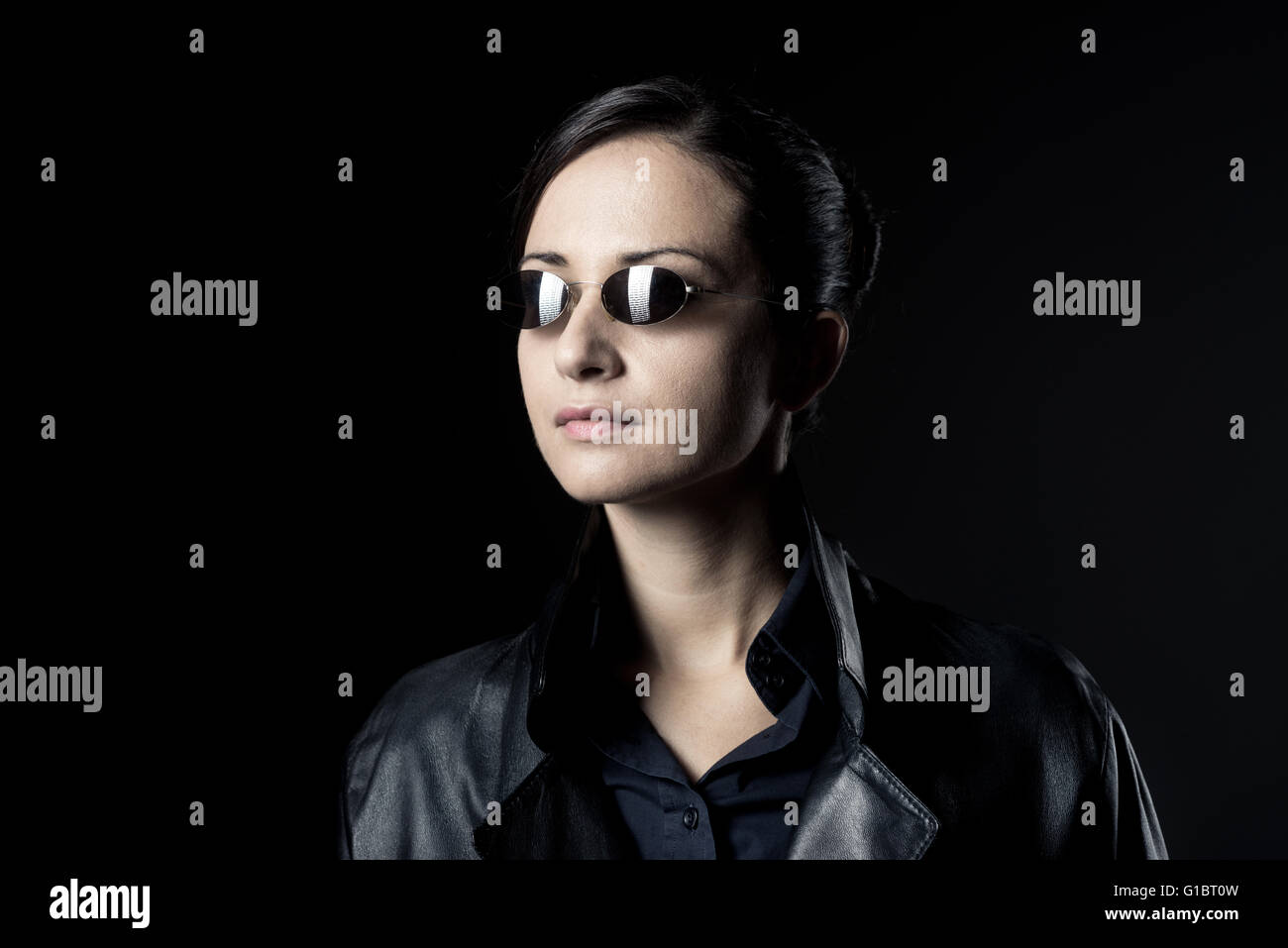 Attractive confident female agent in black leather coat with sunglasses ...