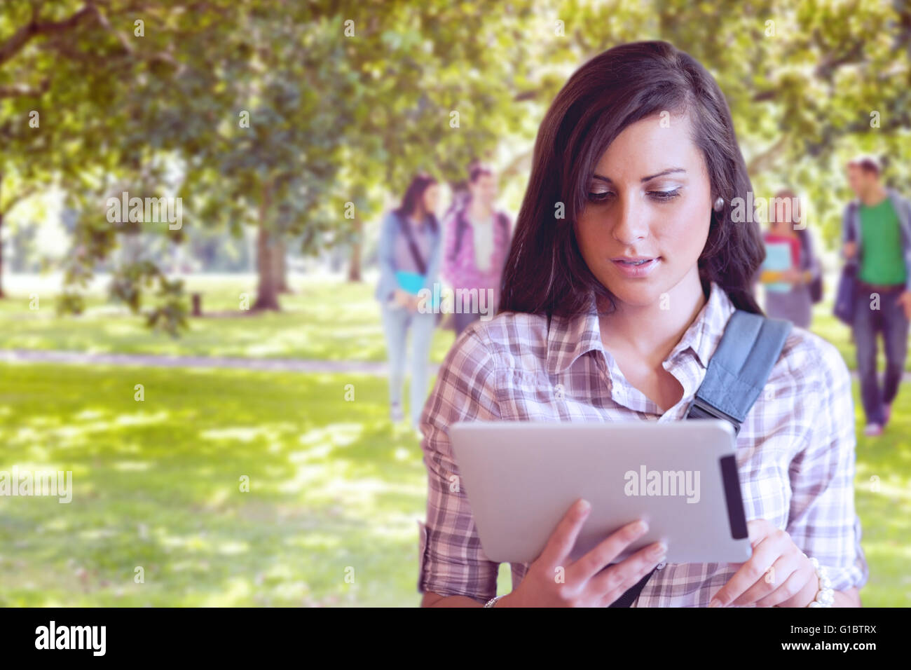 Composite image of young focused student using a tablet computer Stock ...