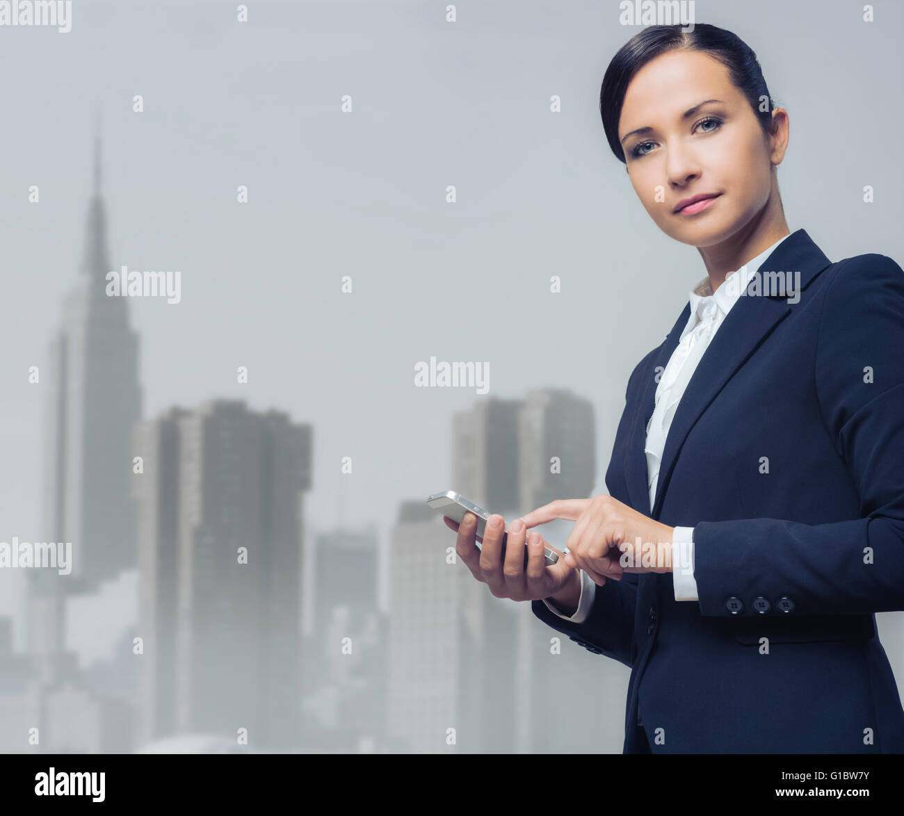 Smiling confident business woman using touch screen mobile phone Stock ...