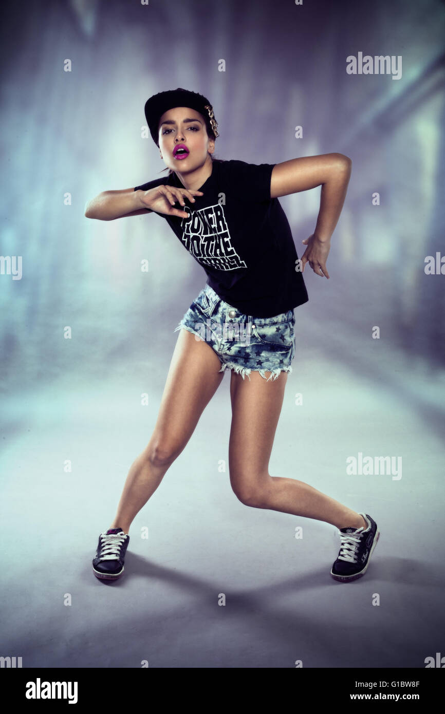 Young urban woman dancing, club style surroundings Stock Photo - Alamy