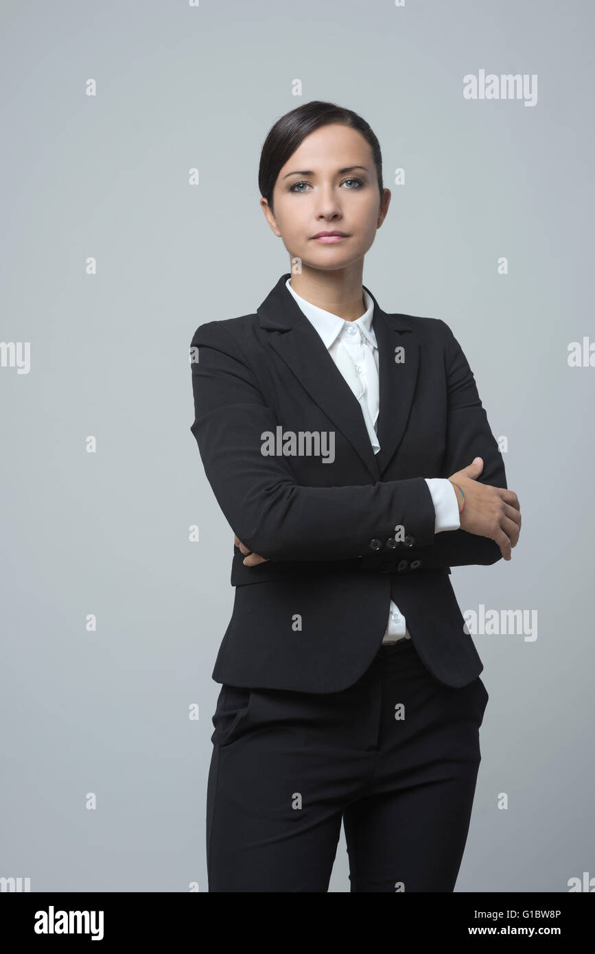 Confident attractive businesswoman posing with arms folded Stock Photo ... Confident attractive businesswoman posing with arms folded Stock Photo ...