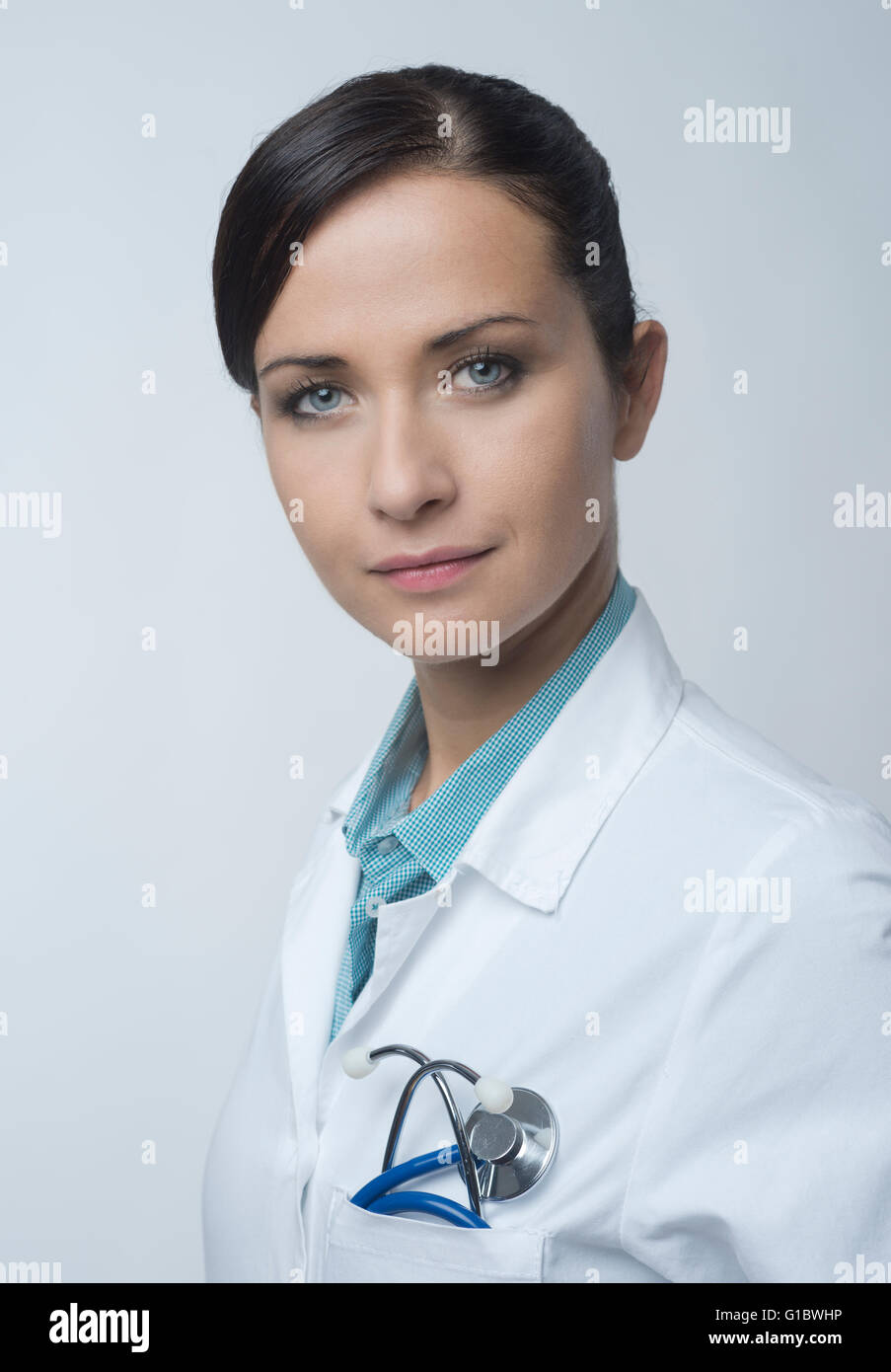 Smiling confident female doctor portrait with lab coat and stethoscope ...