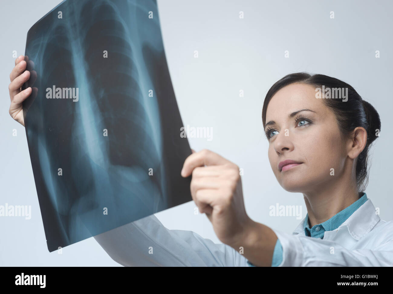 Confident female doctor examining accurately a rib cage x-ray Stock ...