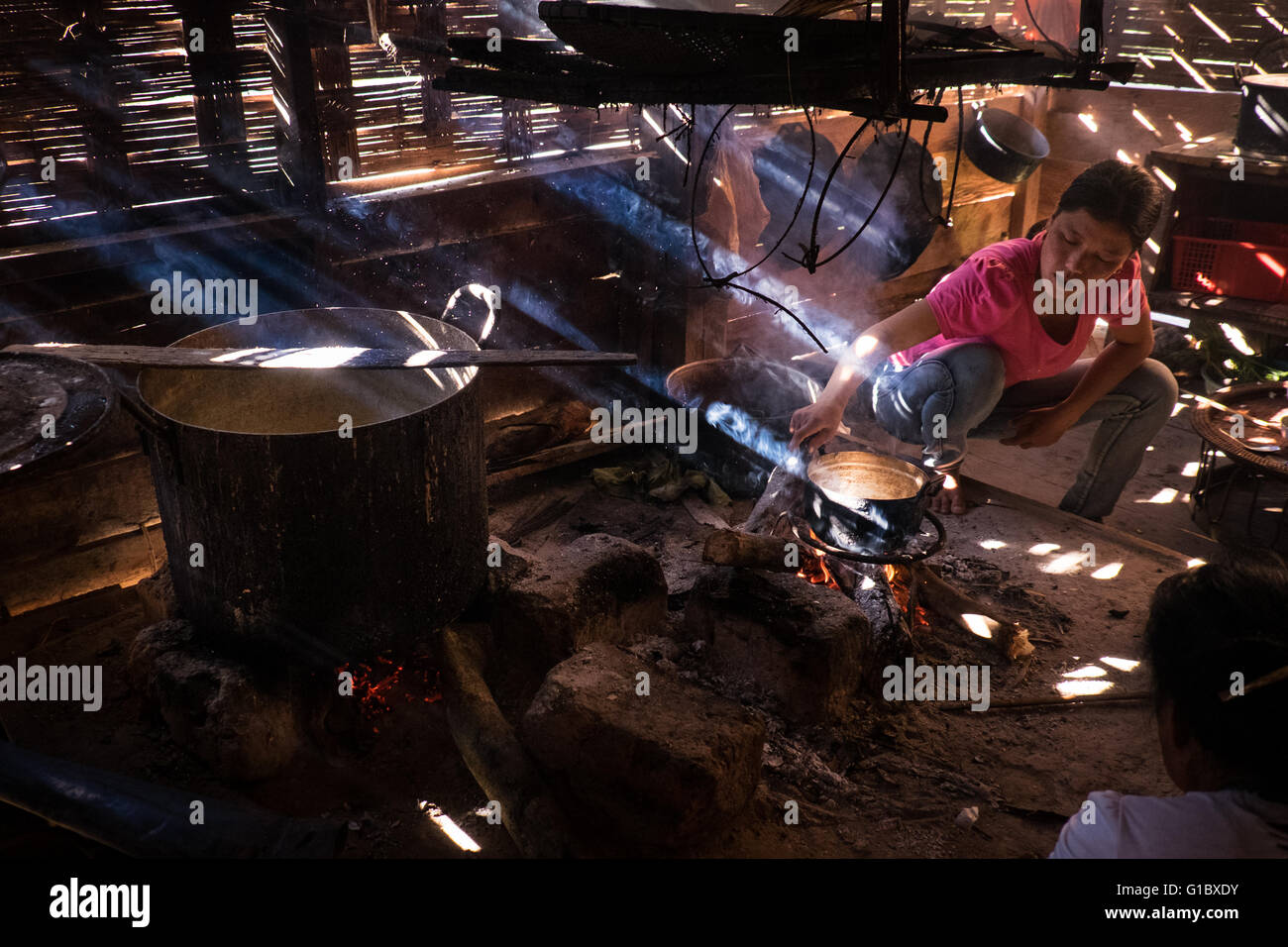 A lady prepares breakfast in a traditional Myanmar kitchen Stock Photo ...