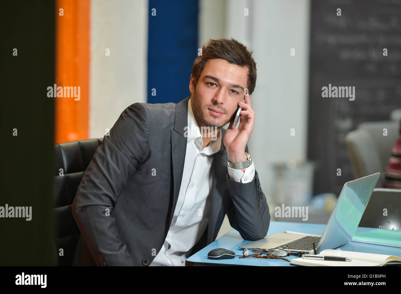 Portrait of smiling Businessman posing in coworking office Stock Photo ...
