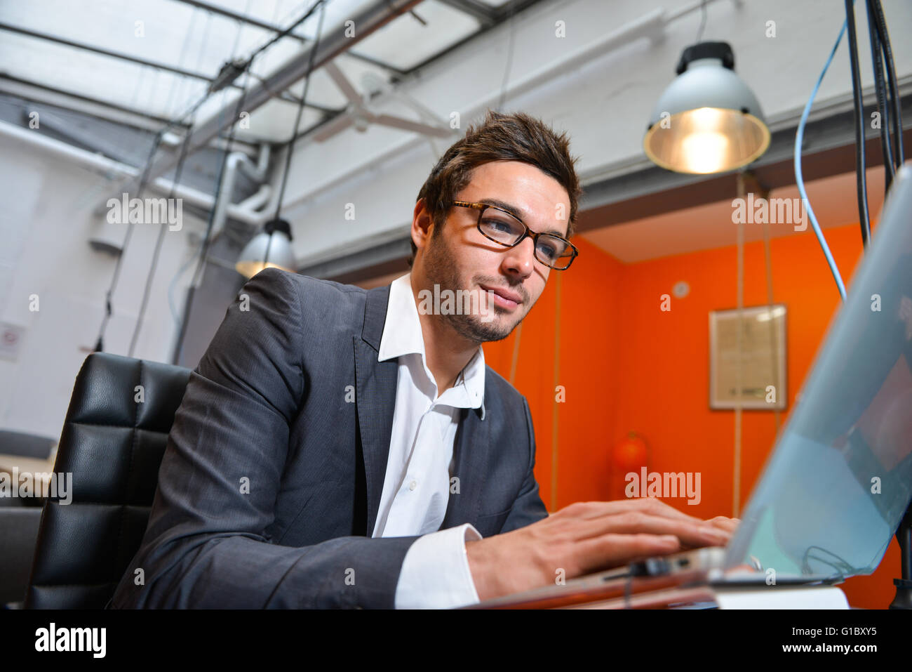 Portrait of smiling Businessman posing in coworking office Stock Photo ...