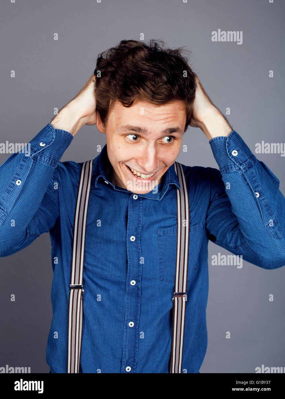 young goofy man with pimples pointing in studio, stupid bookwarm little ...