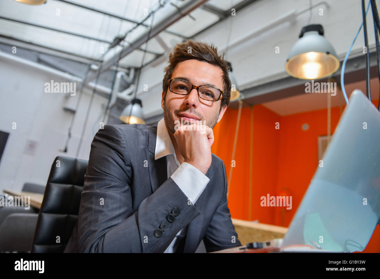 Portrait of smiling Businessman posing in coworking office Stock Photo ...