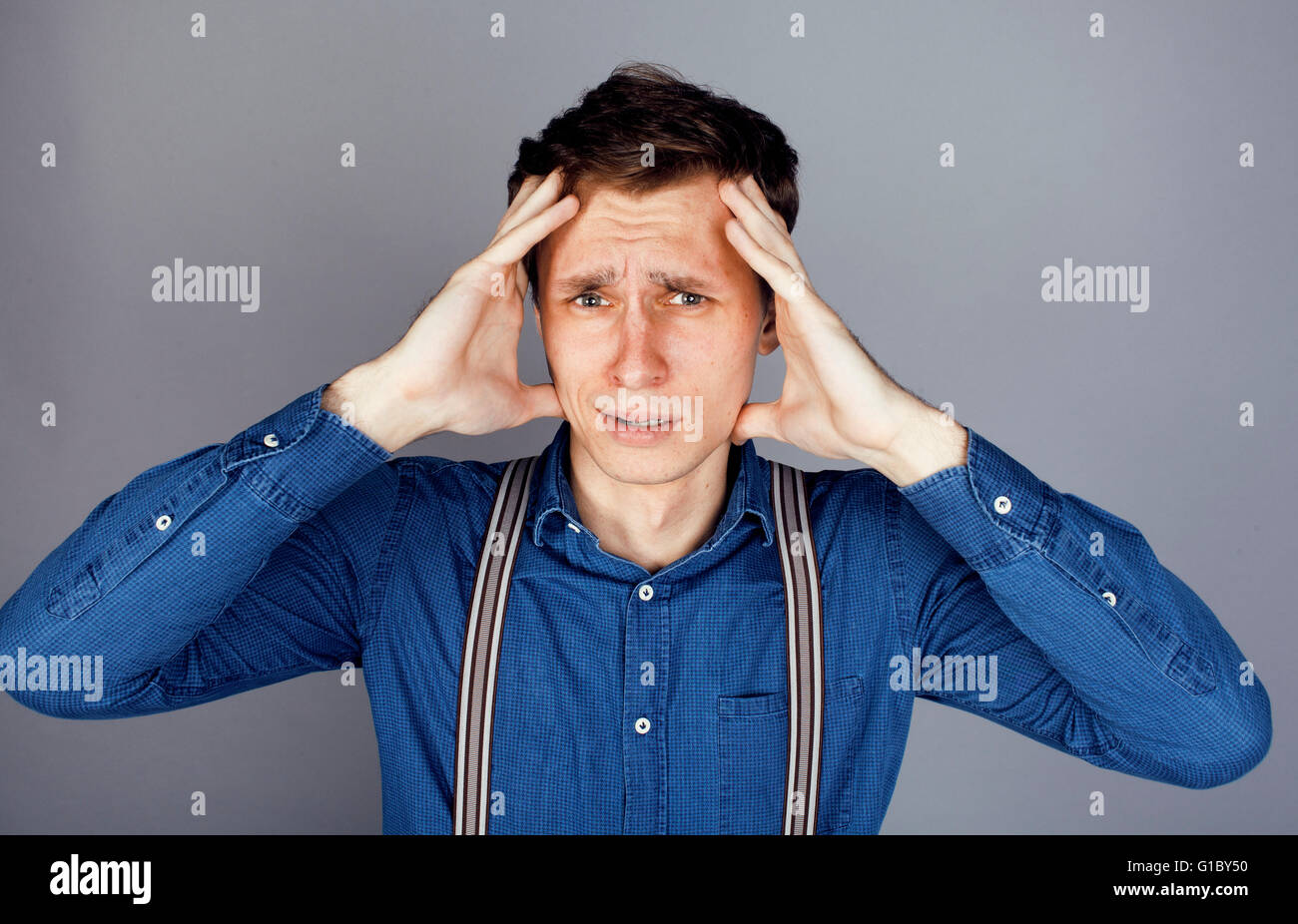 young goofy man with pimples pointing in studio Stock Photo - Alamy