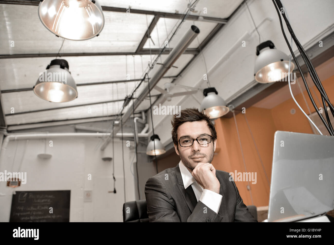 Portrait of smiling Businessman posing in coworking office Stock Photo ...